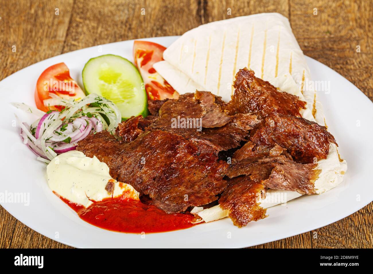 Doner in the plate with meat, vegetables and sauce Stock Photo - Alamy