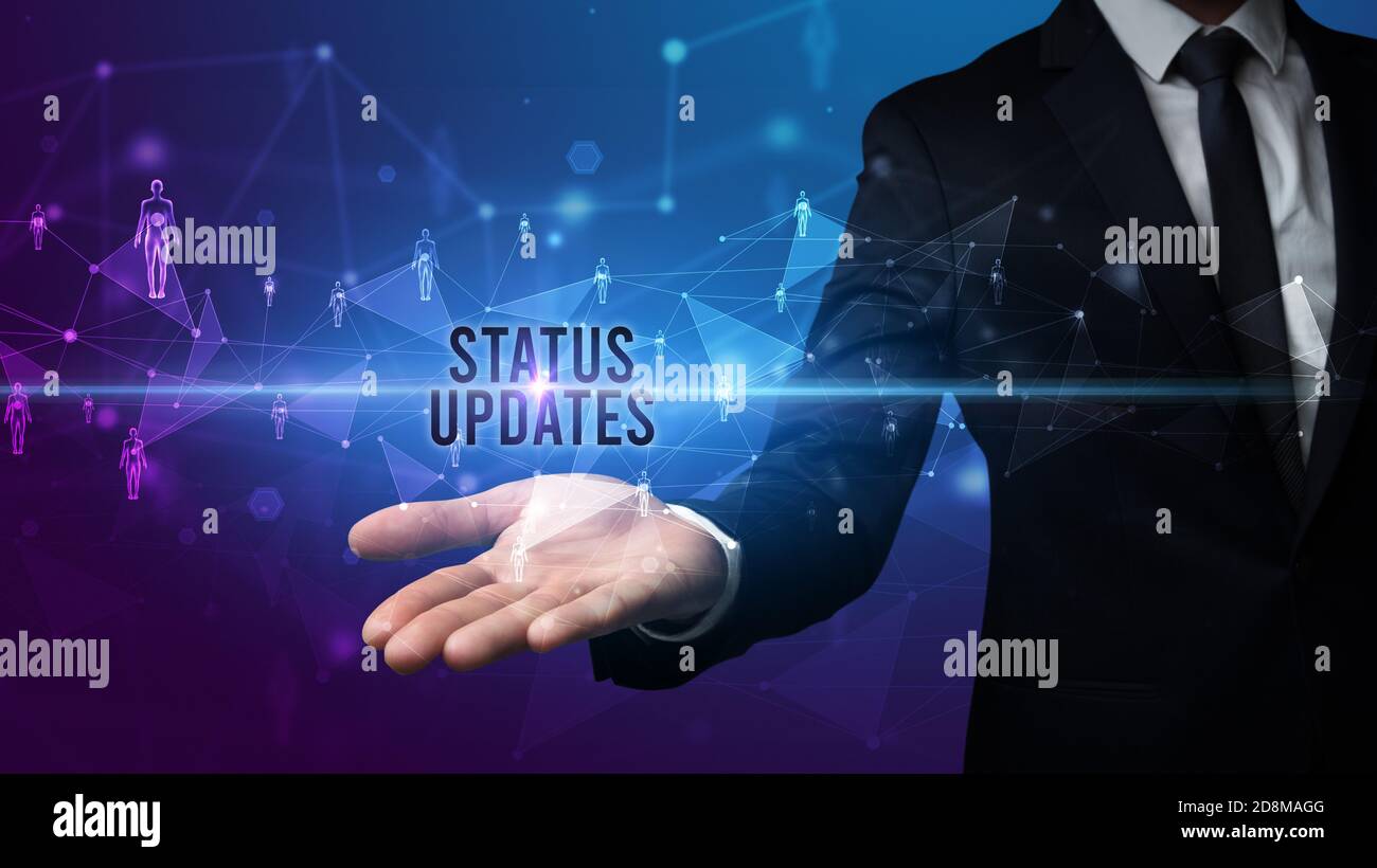 Elegant hand holding STATUS UPDATES inscription, social networking ...