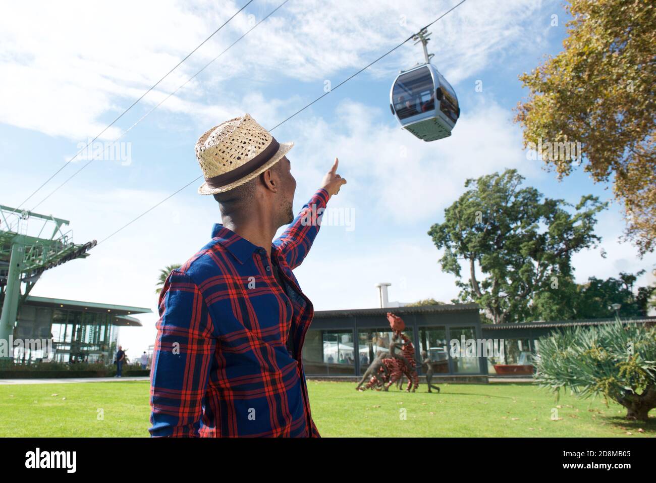 Side portrait of african american man pointing finger to cable car ...