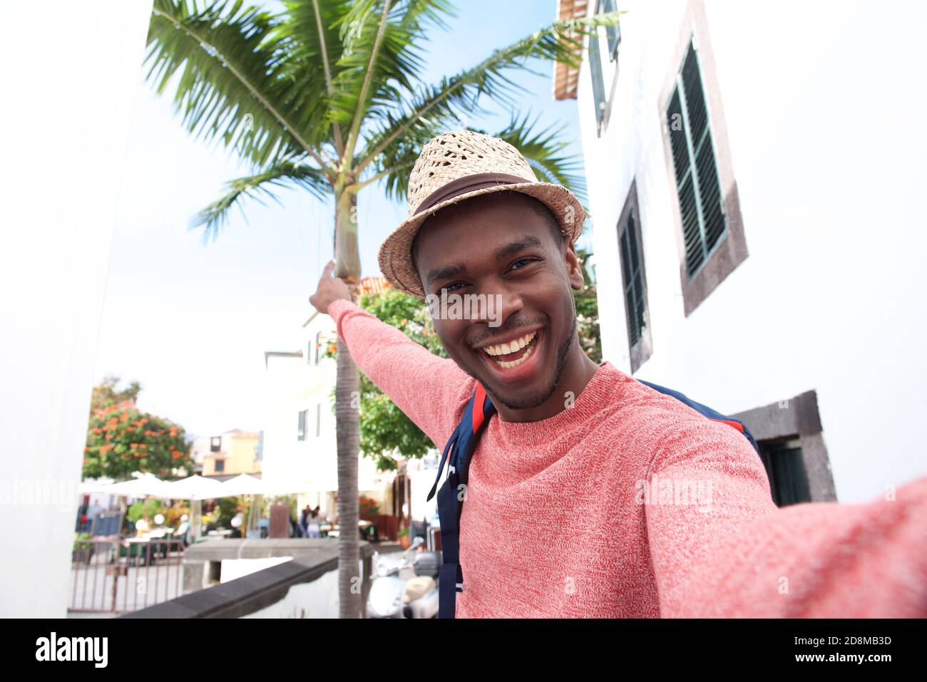 Portrait of handsome young black man smiling while taking selfie on ...