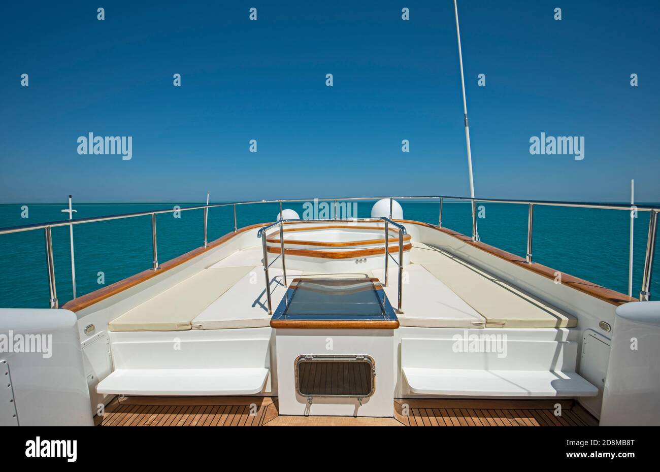 View over the bow of a large luxury motor yacht on tropical open ocean ...