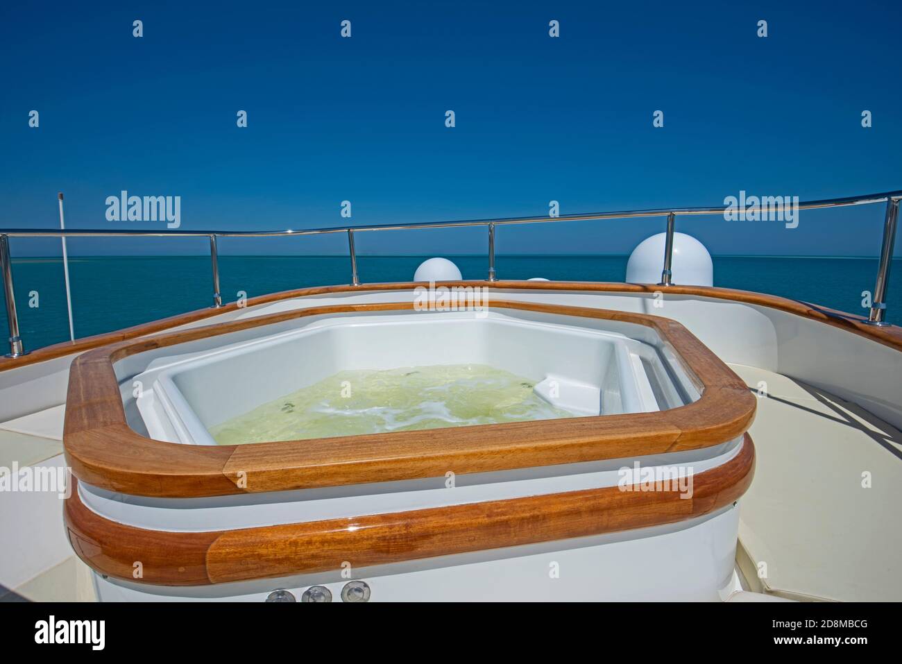 View over the bow of a large luxury motor yacht on tropical open ocean ...