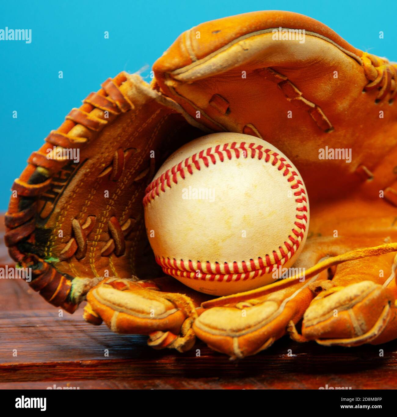 A weather leather baseball glove with a baseball inside the mitt Stock ...