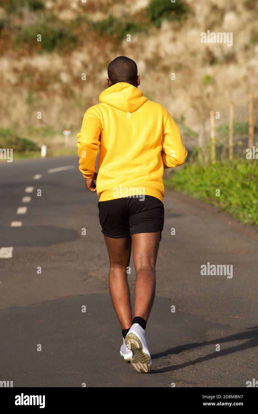 Full body portrait from behind of african american sport man running on ...