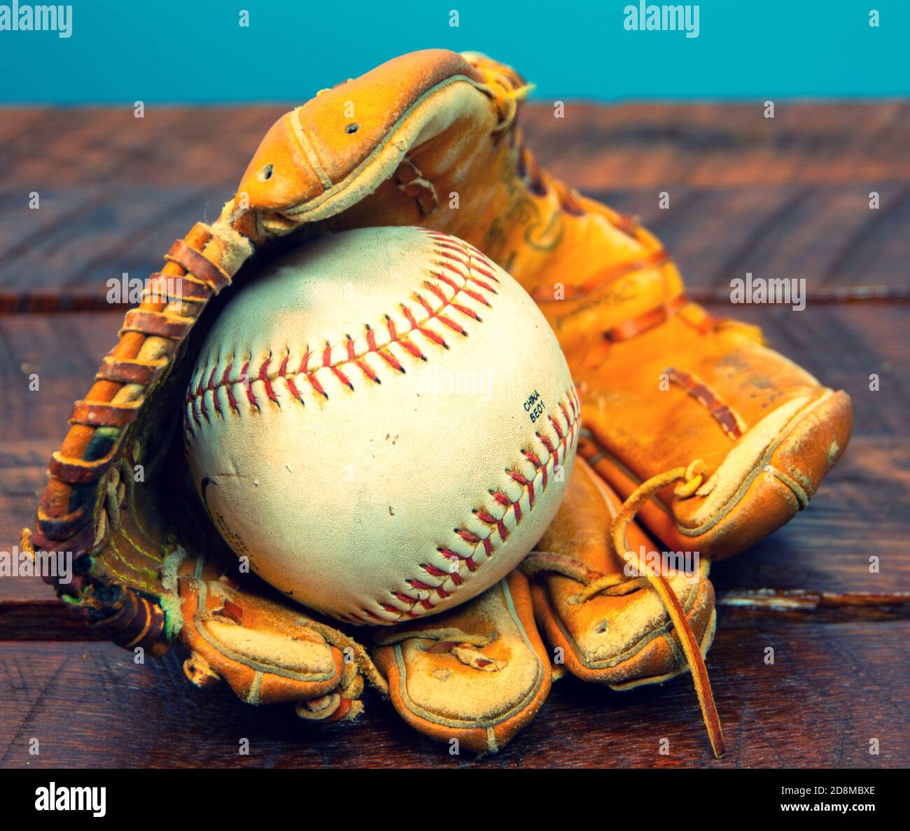 Softball resting in tan leather baseball mitt Stock Photo - Alamy