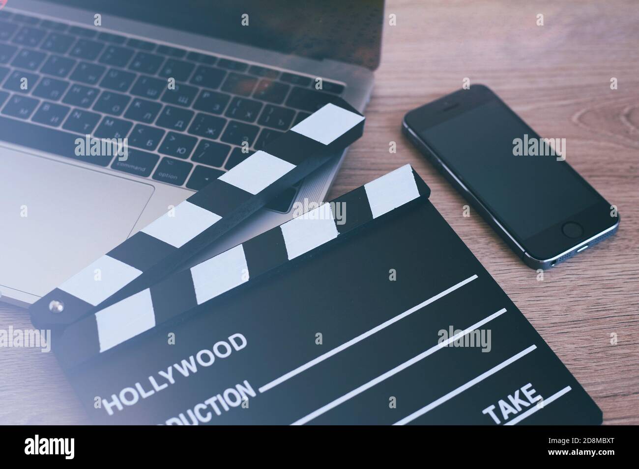 Movie clapper laptop and smart phone on the wood table Stock Photo - Alamy