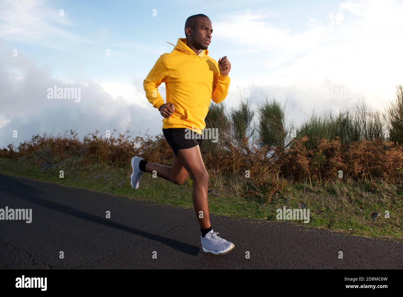 Full body portrait of fit young black guy running on street Stock Photo ...