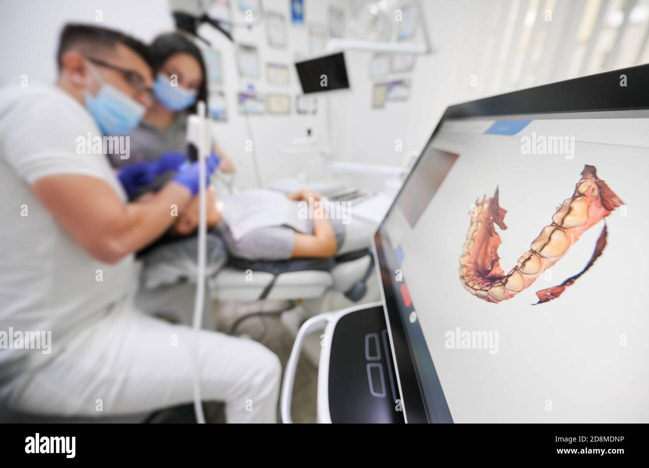 Dentist scanning patient's teeth with modern scanning machine. Digital ...