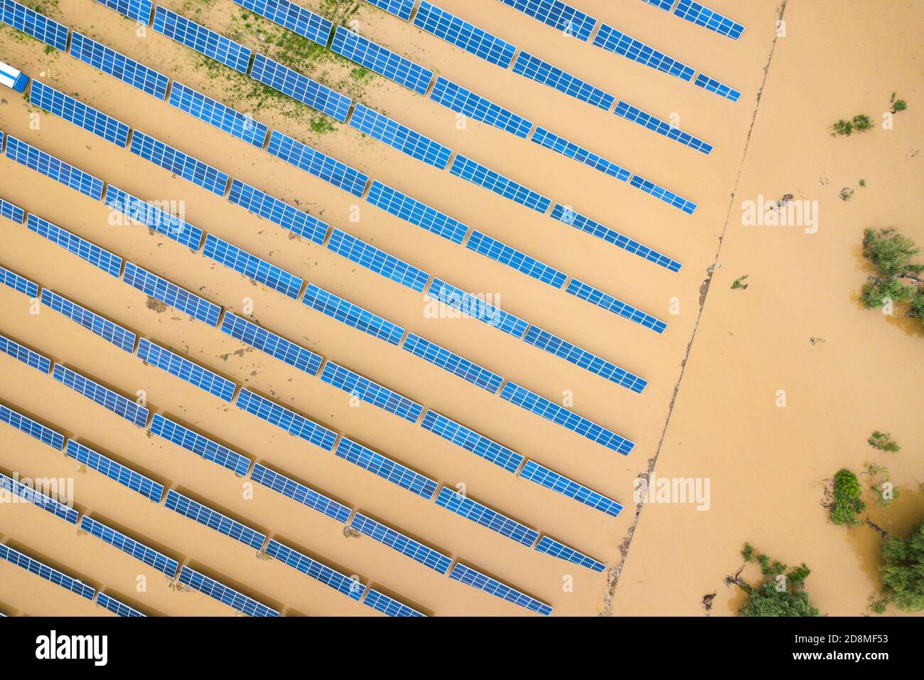 Aerial view of flooded solar power station with dirty river water in ...