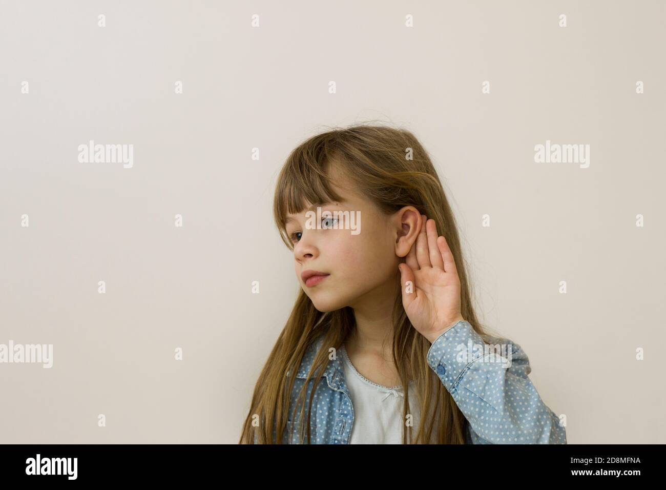 Young pretty child girl with long loose hair, dreamy eyes and serious ...