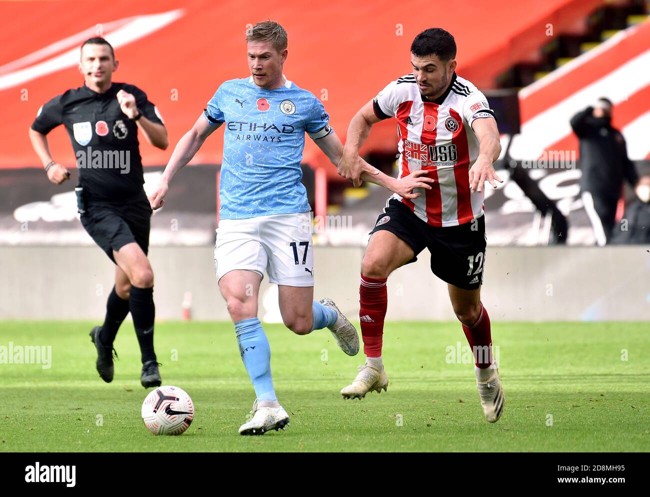 Manchester City's Kevin De Bruyne (left) and Sheffield United's John ...