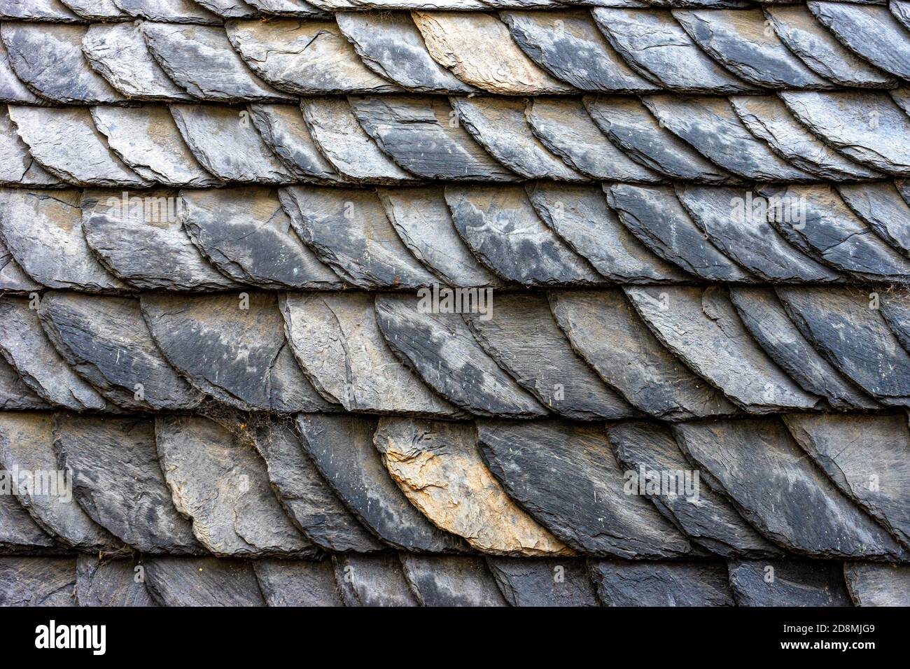 High angle shot of old stone roof tiles on a facade house Stock Photo ...