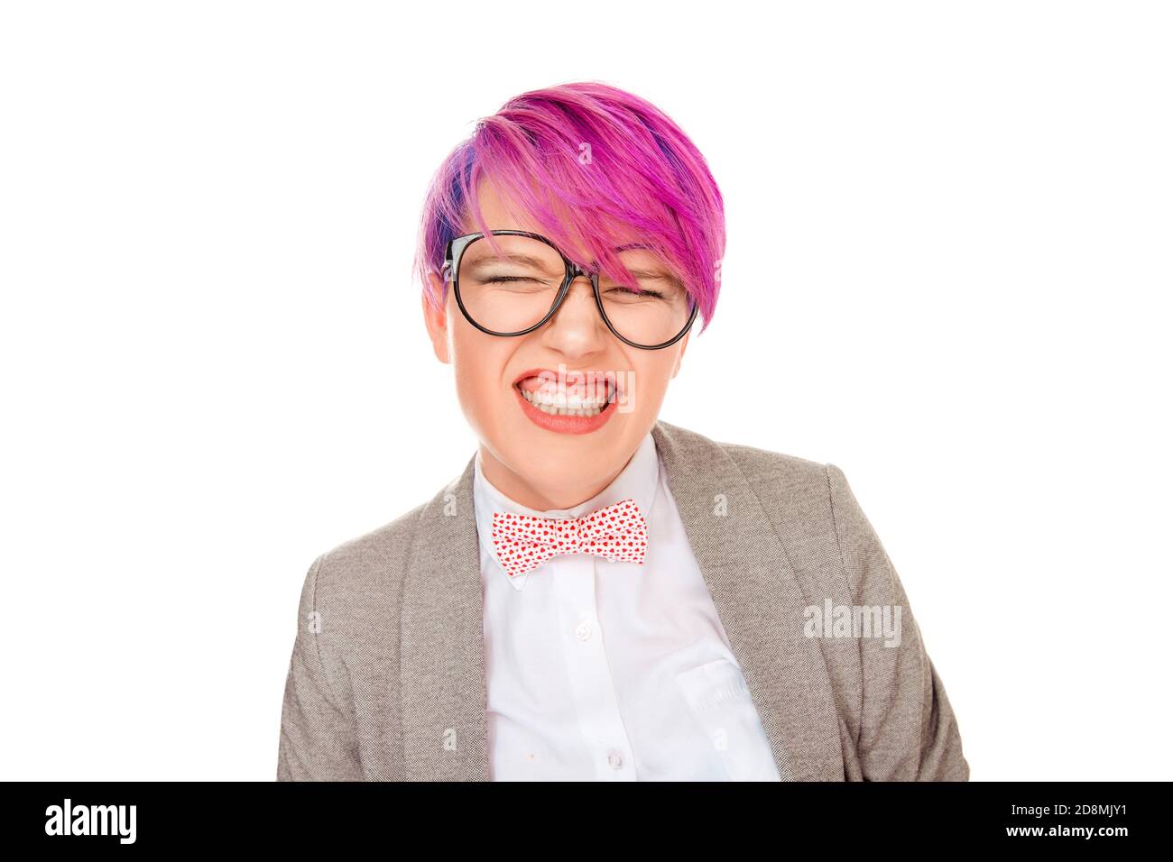 Disgusted woman with pink hair pursing her lips and making a funny face ...