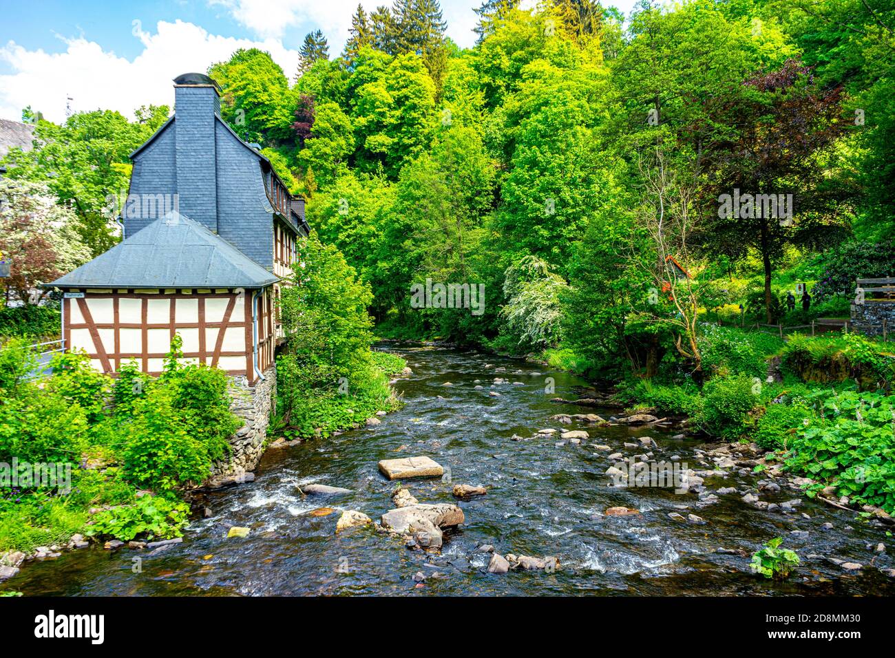 Landscape of flowing water in a small stream along with houses and ...