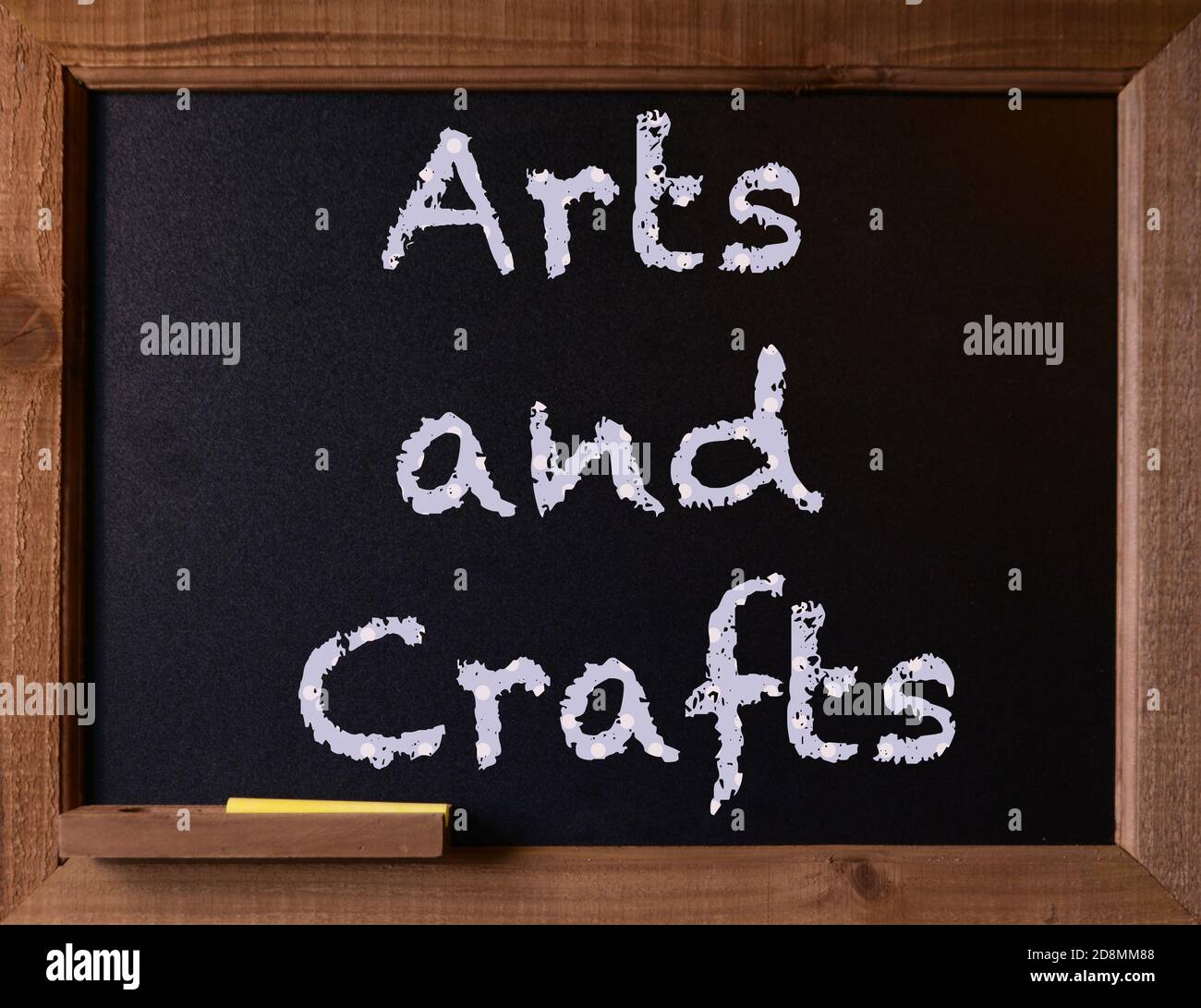 The message, "Arts and Crafts" is written on a chalkboard, with wood ...