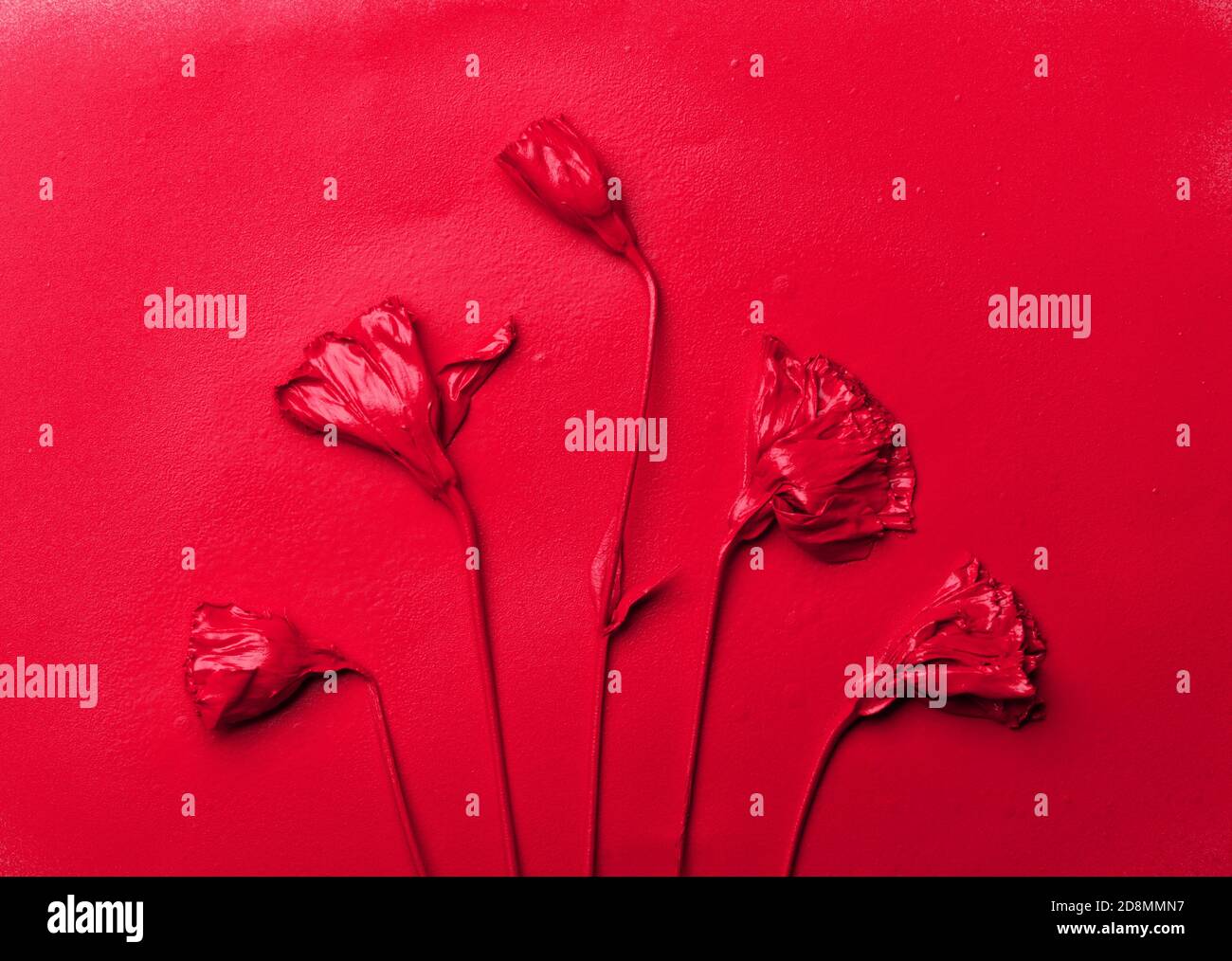 Bright spray painted red eustoma flower on a red paper background with ...