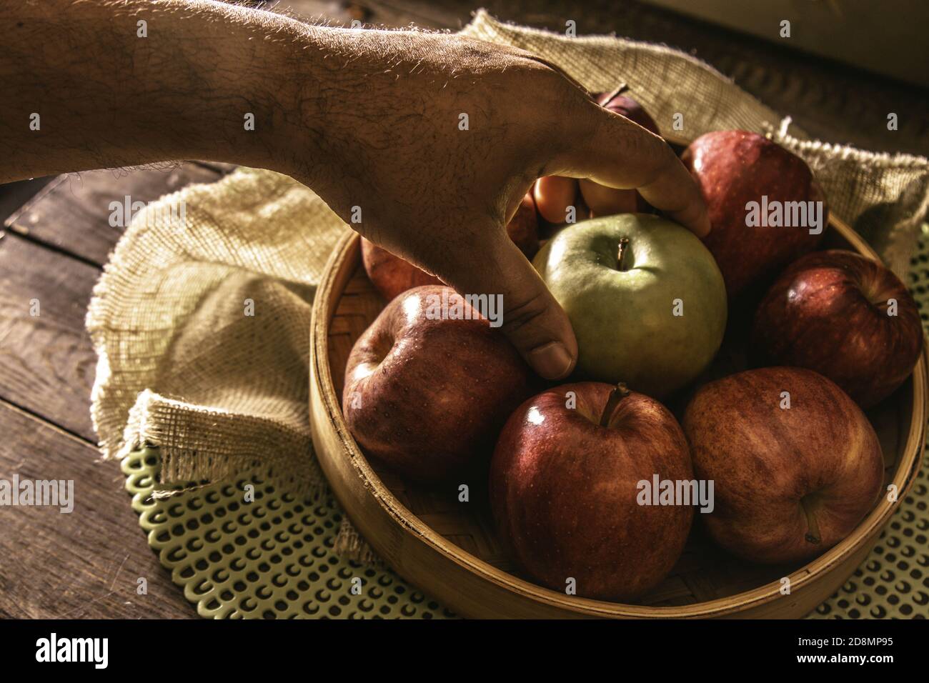 Hand taking red apple hi-res stock photography and images - Alamy