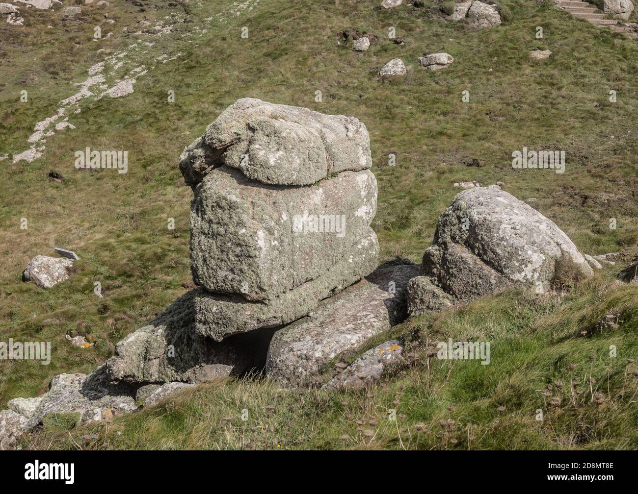 Large rocks like human head on the shoreline at lands end Cornwall ...