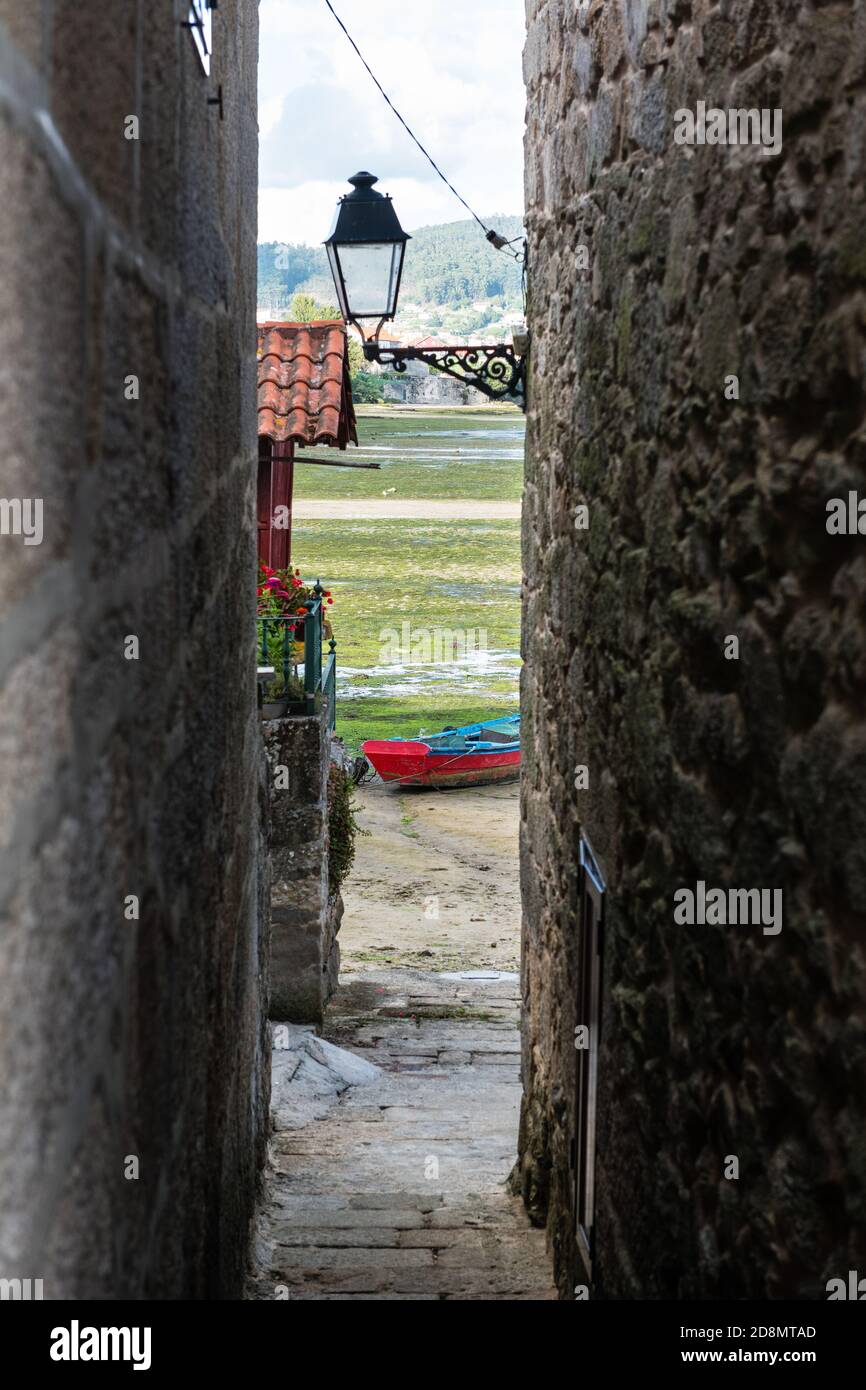 The Ria the Pontevedra as seen through a narrow stone street in the ...