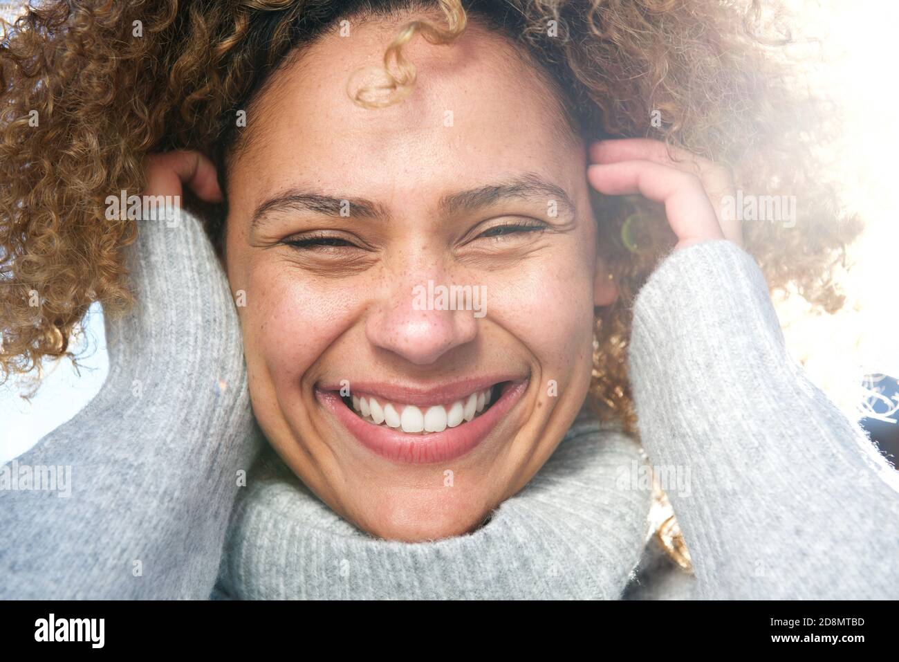 Close up portrait of cheerful young african american woman laughing ...