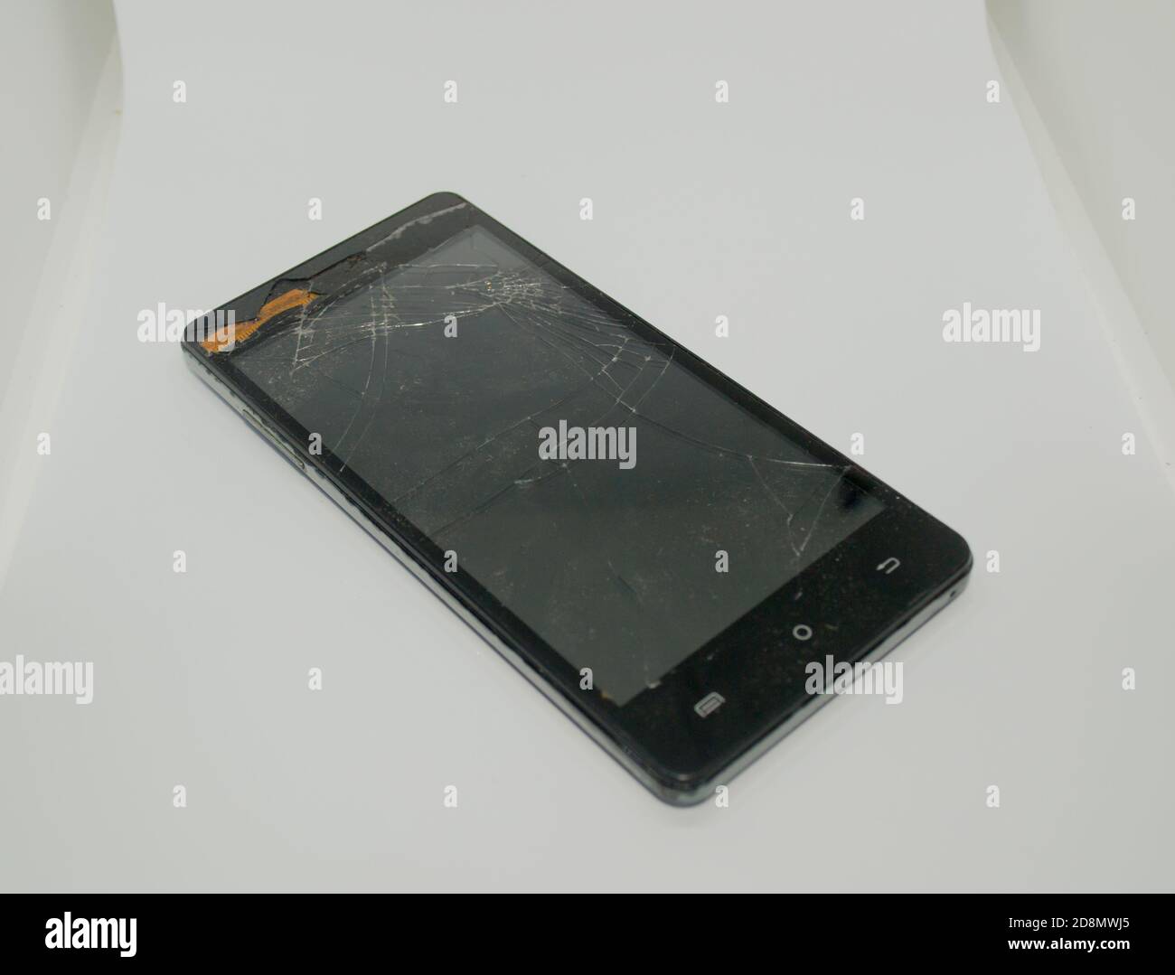 A color black mobile smartphone with a crashed/cracked or broken screen ...