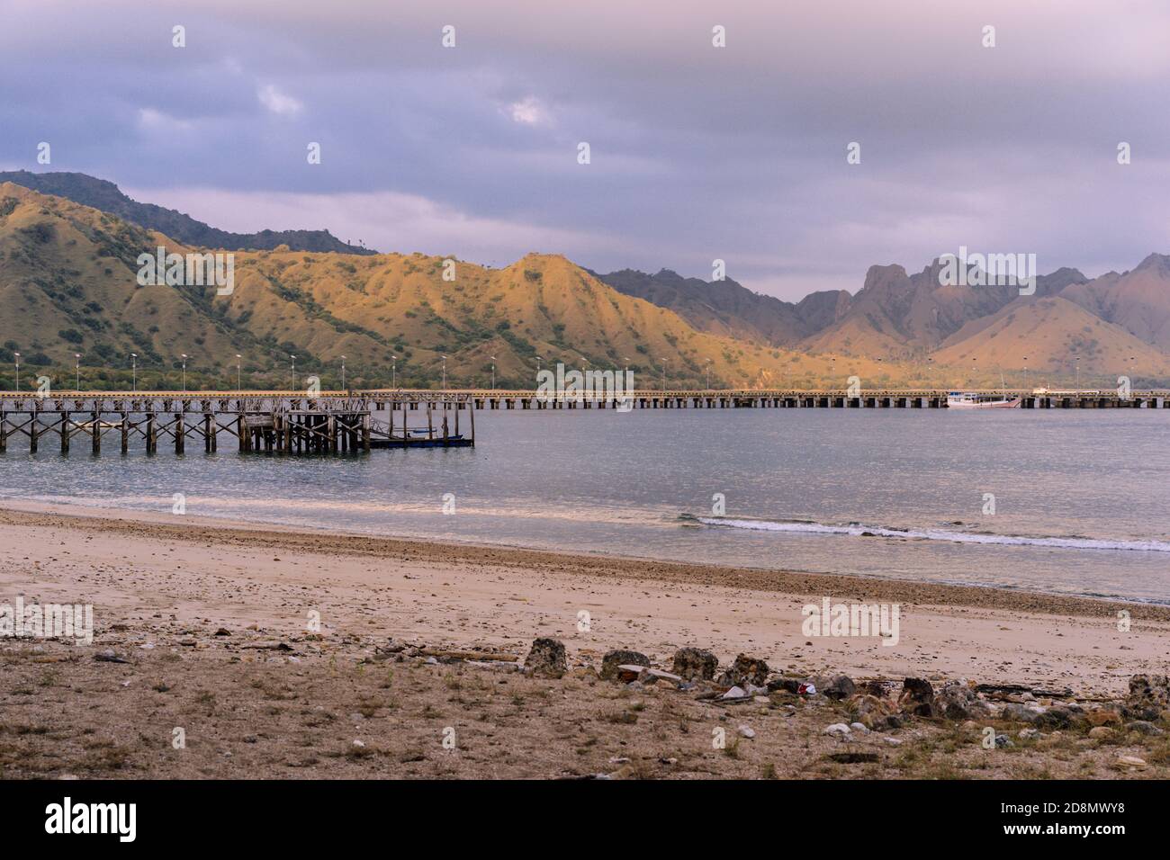 Sea bay in the mountains, pier at Komodo island, entrance to UNESCO ...