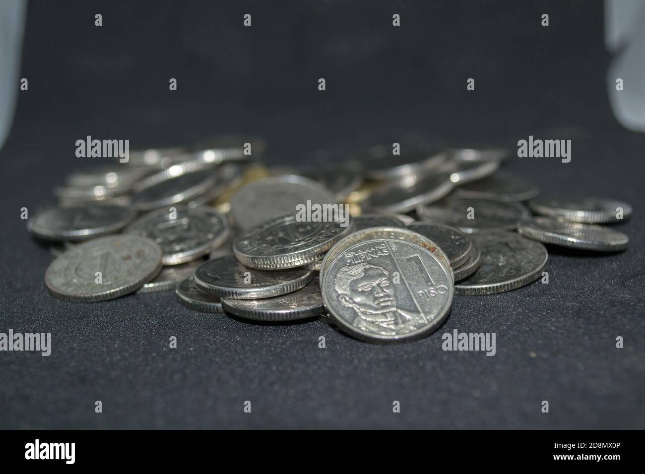 close up image of a pile of Philippine Peso coins under President ...