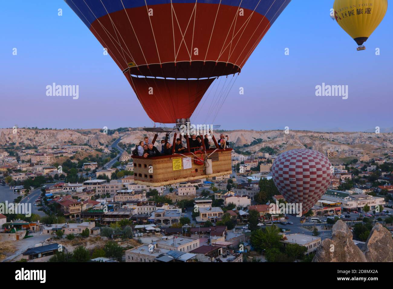 Tourists in hot air balloon fly close in Cappadocia, Turkey Stock Photo ...