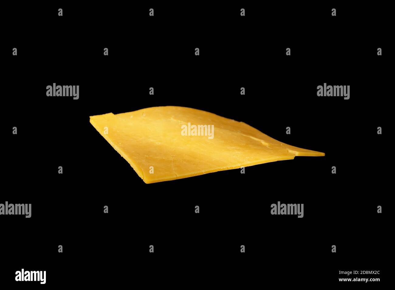 Slice of cheddar cheese isolated on black background flying prepared ...