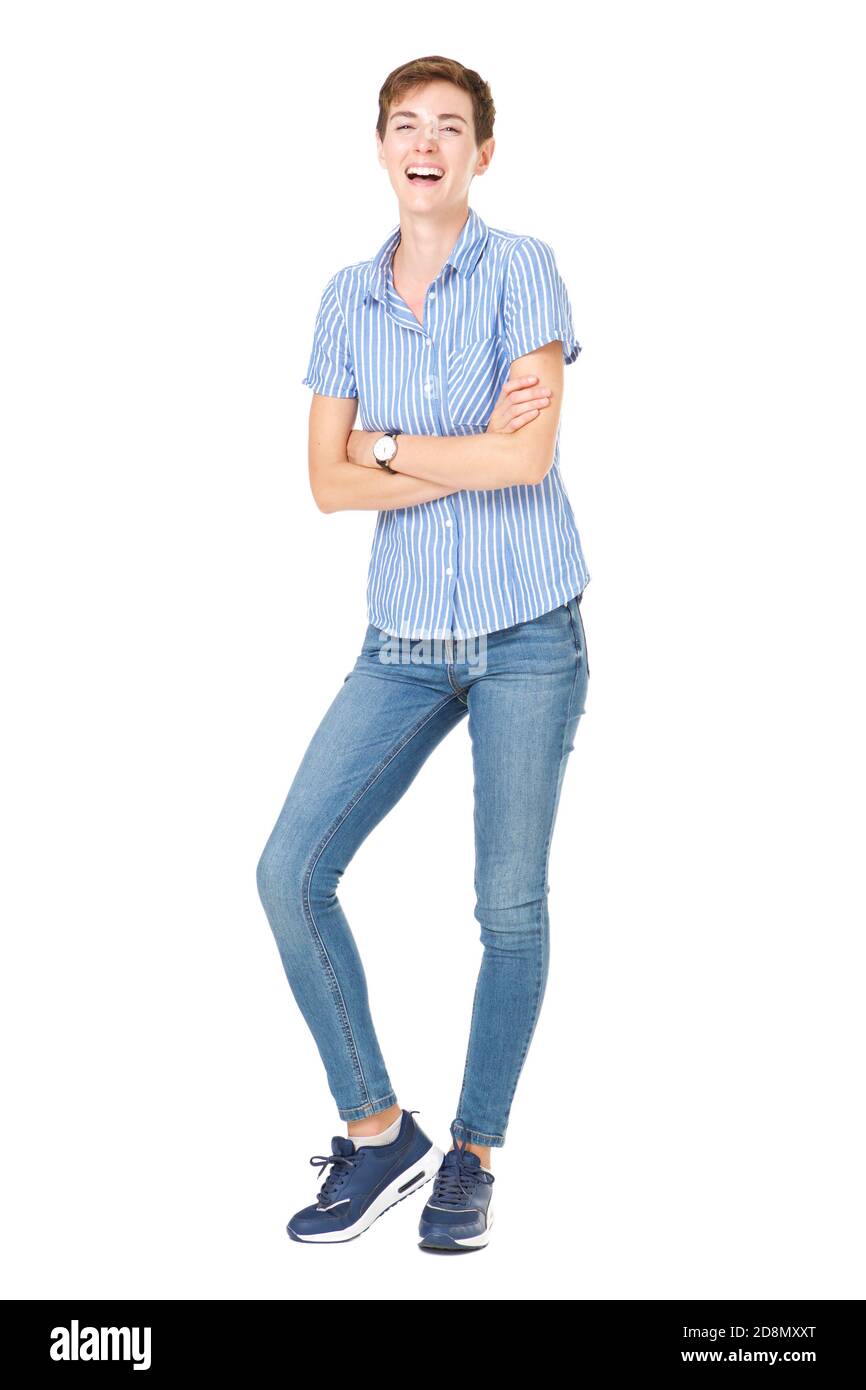 Full length portrait of young woman with short hair laughing against ...