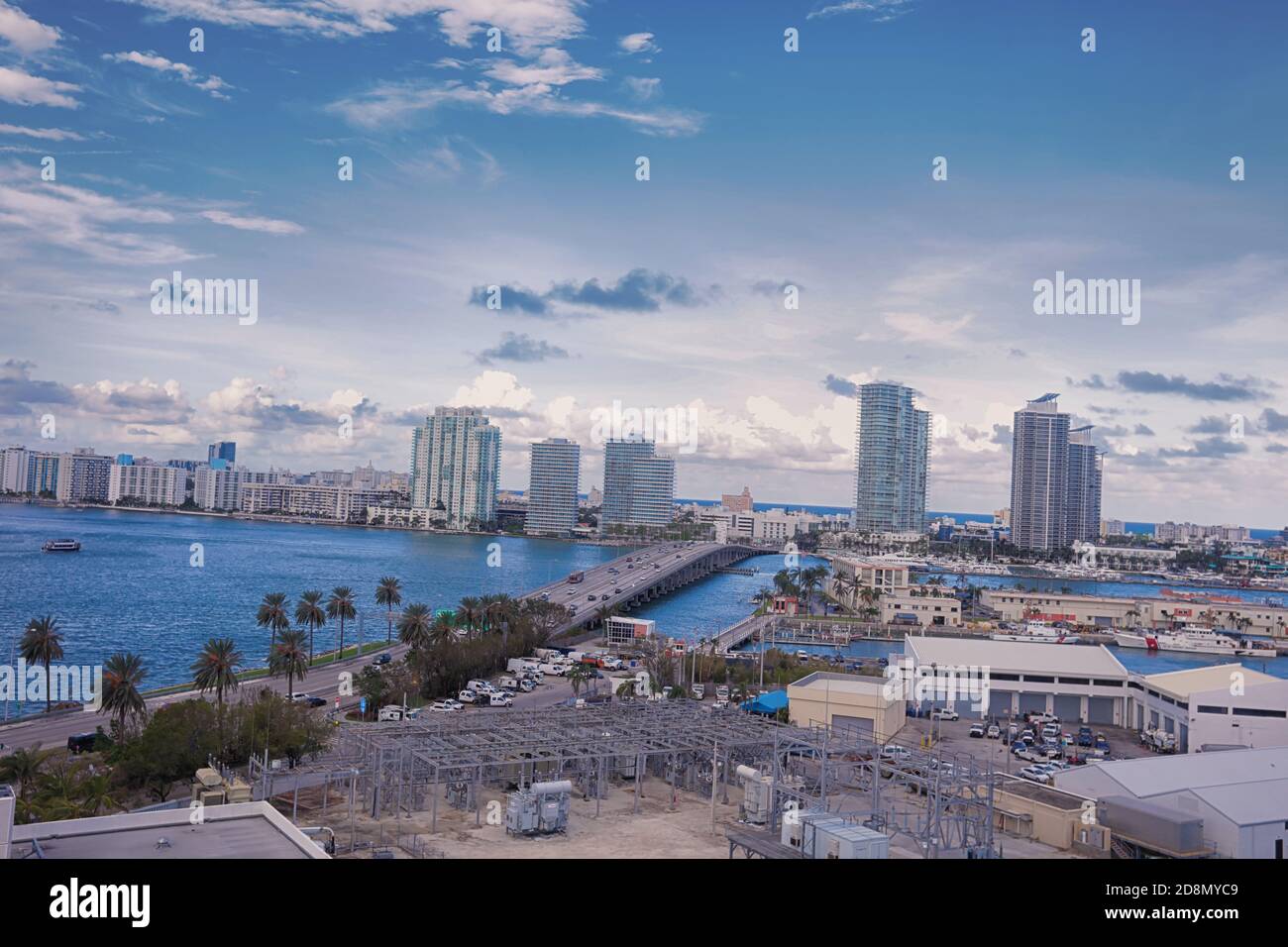 Aerial view of Miami skyscrapers with blue cloudy sky,white boat ...