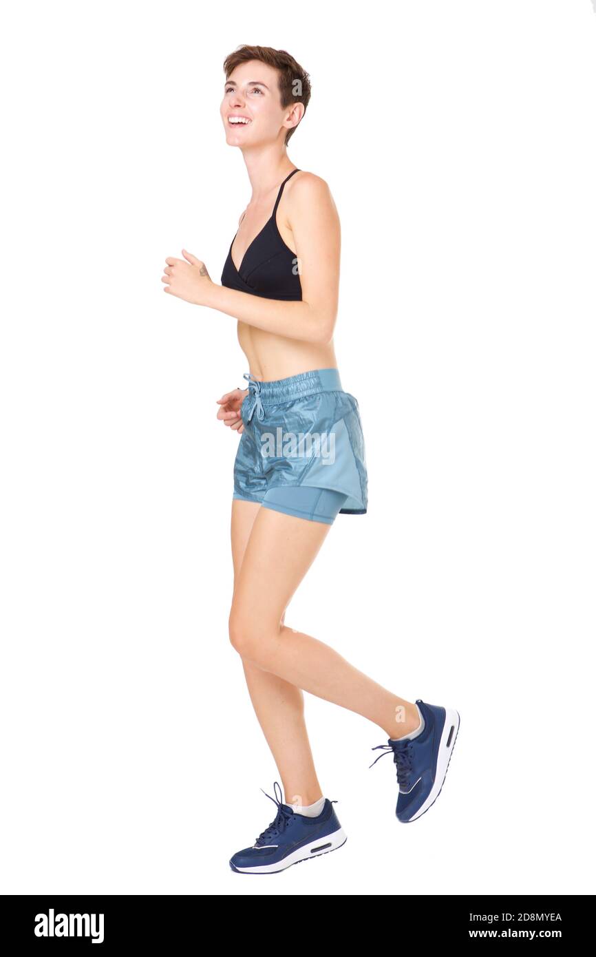 Full length side portrait of healthy woman running on isolated white ...