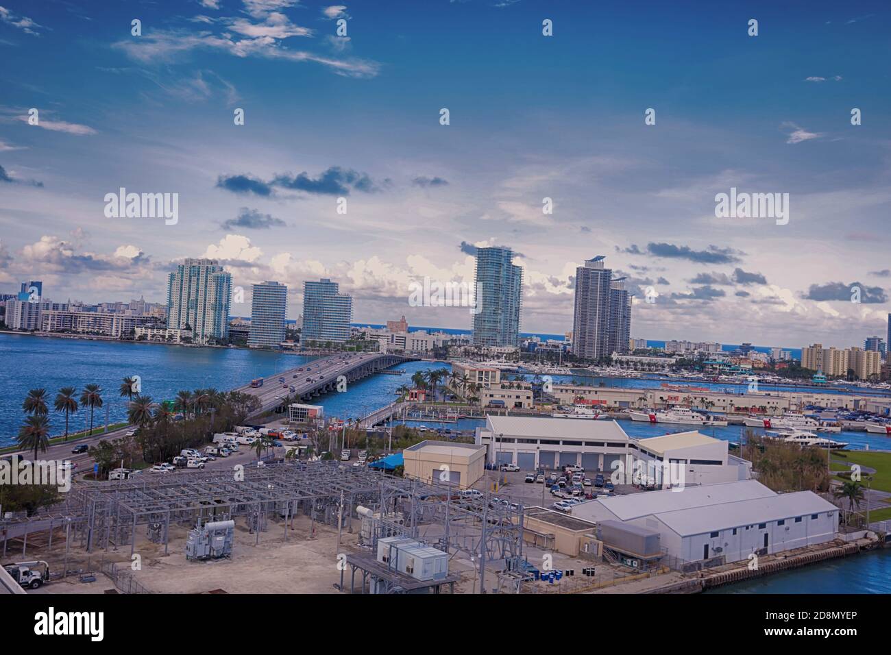 Aerial view of Miami skyscrapers with blue cloudy sky,white boat ...
