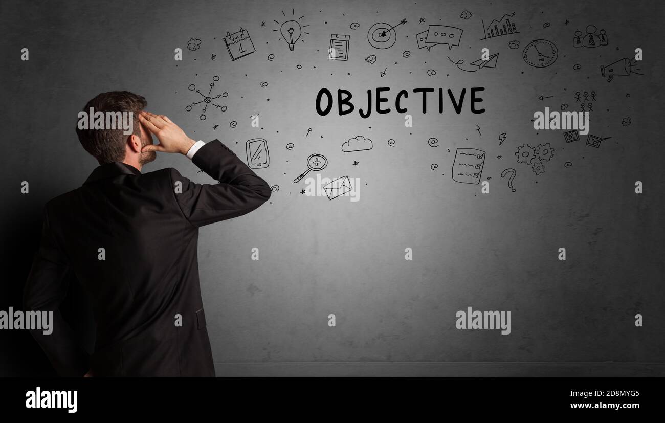businessman drawing a creative idea sketch with OBJECTIVE inscription ...