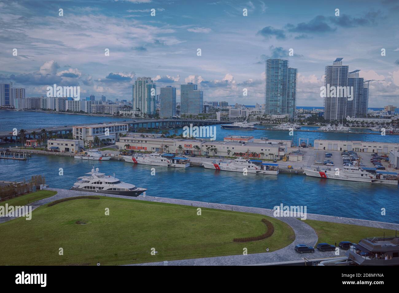 Aerial view of Miami skyscrapers with blue cloudy sky,white boat ...