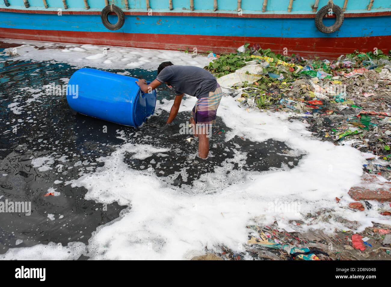 Man Throwing Garbage In The River