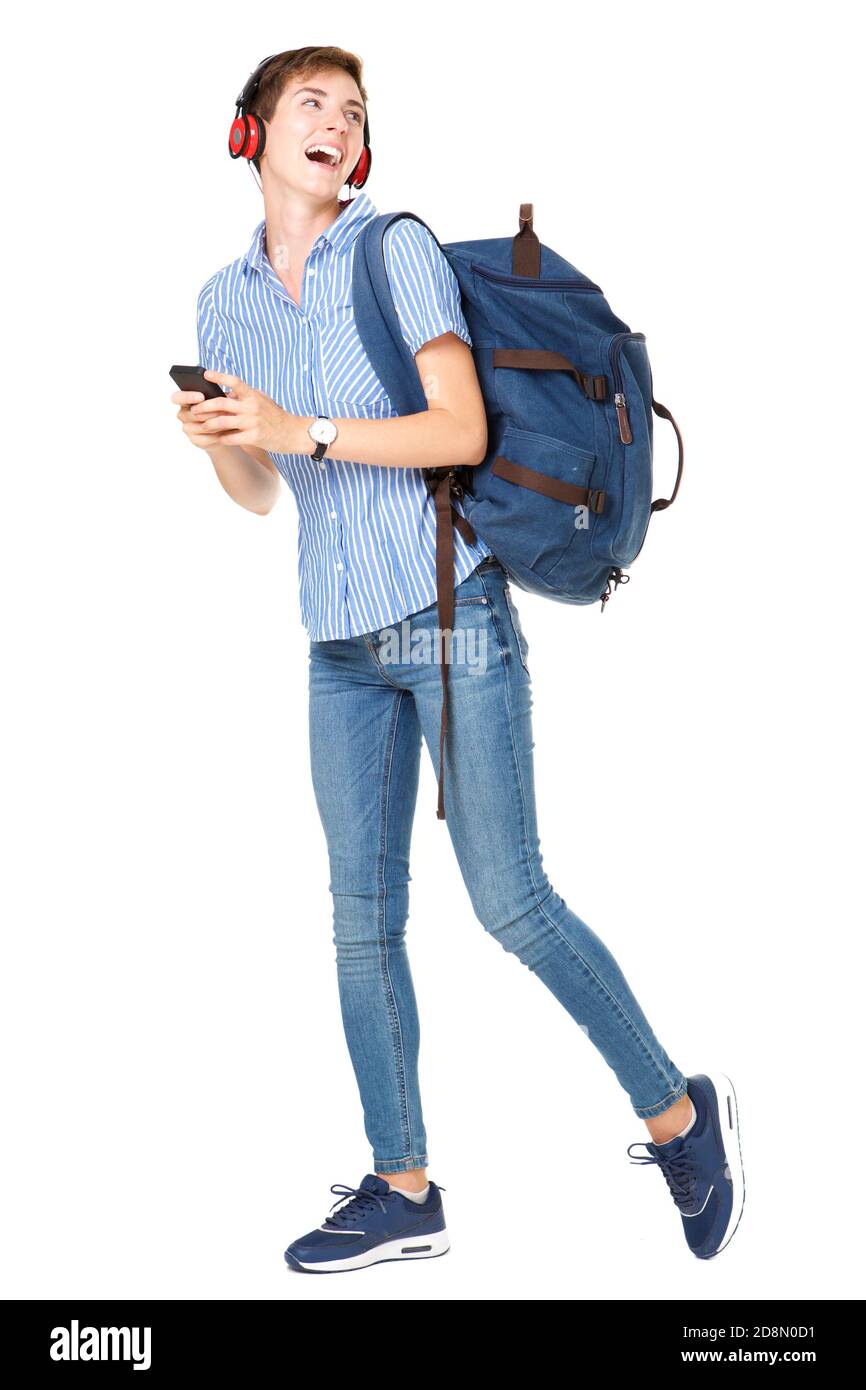 Full body portrait of happy young woman listening to music with smart ...