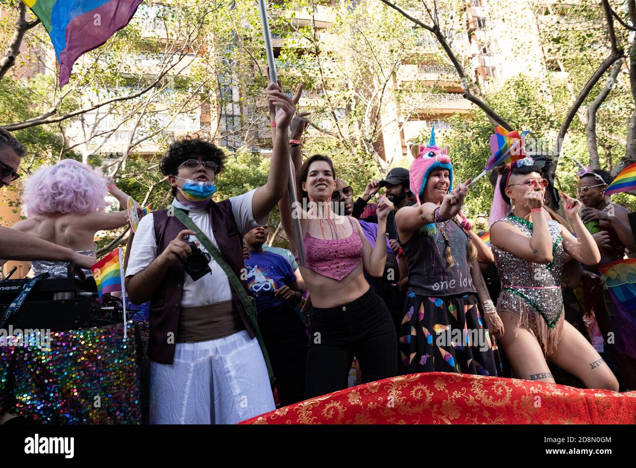Activists seen waving rainbow flags and dancing on a decorated vehicle ...