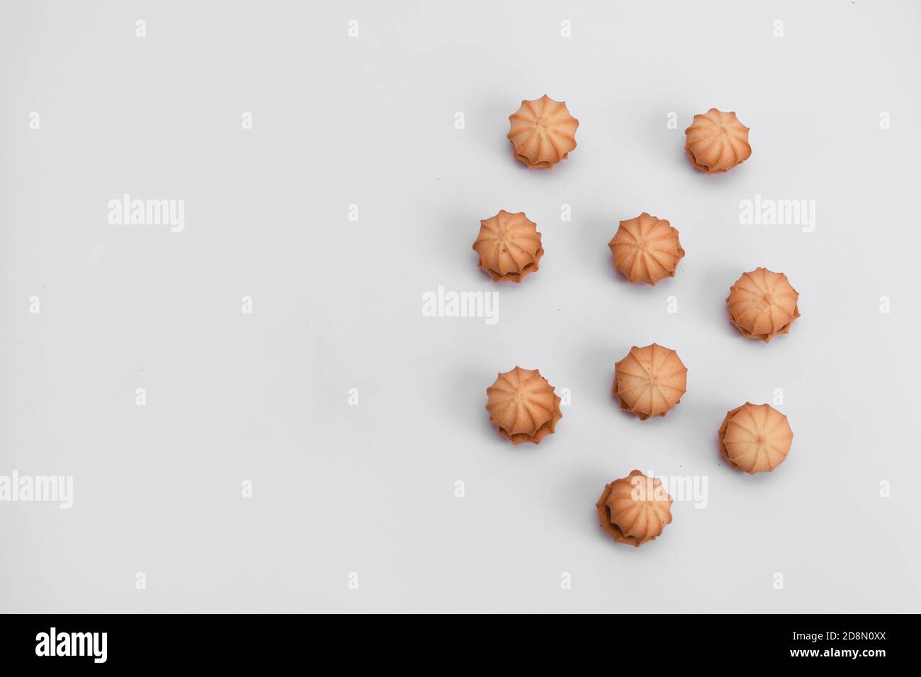 Cookies spread out on a white isolated background, top view, with copy ...