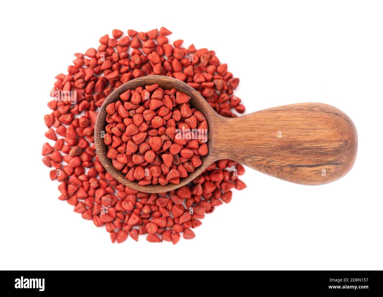 Annatto seeds in wooden spoon, isolated on white background. Achiote ...