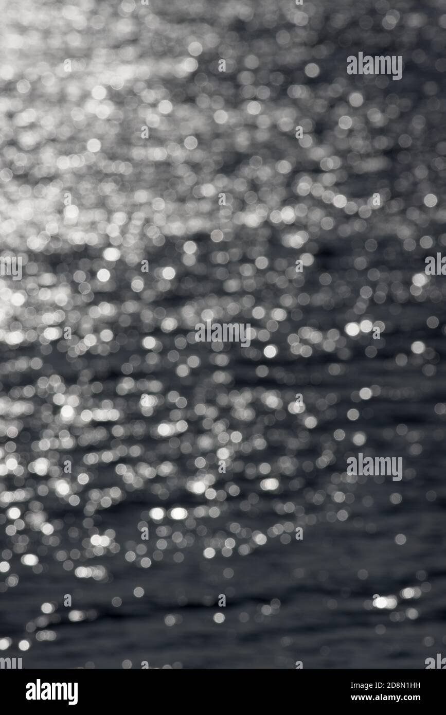 5 - Defocused vertical image of sunny water ripples, forming an ...