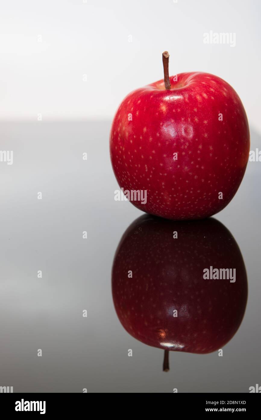Fresh red apple isolated and reflected on a black glass surface Stock ...