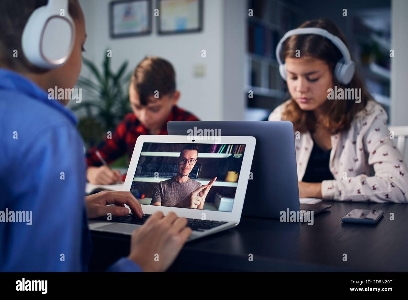 Online school lesson. Children learning via internet with laptops at ...