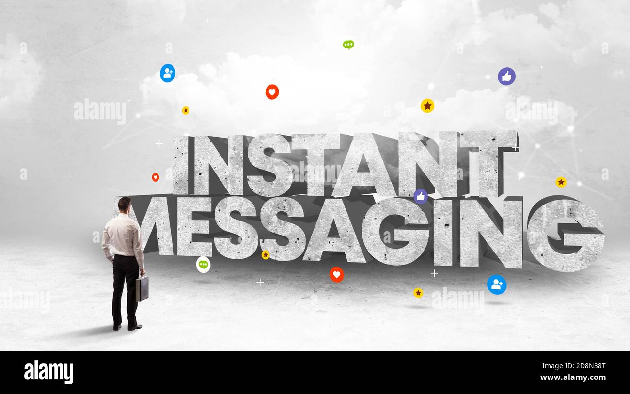 Young businessman standing in front of INSTANT MESSAGING inscription ...