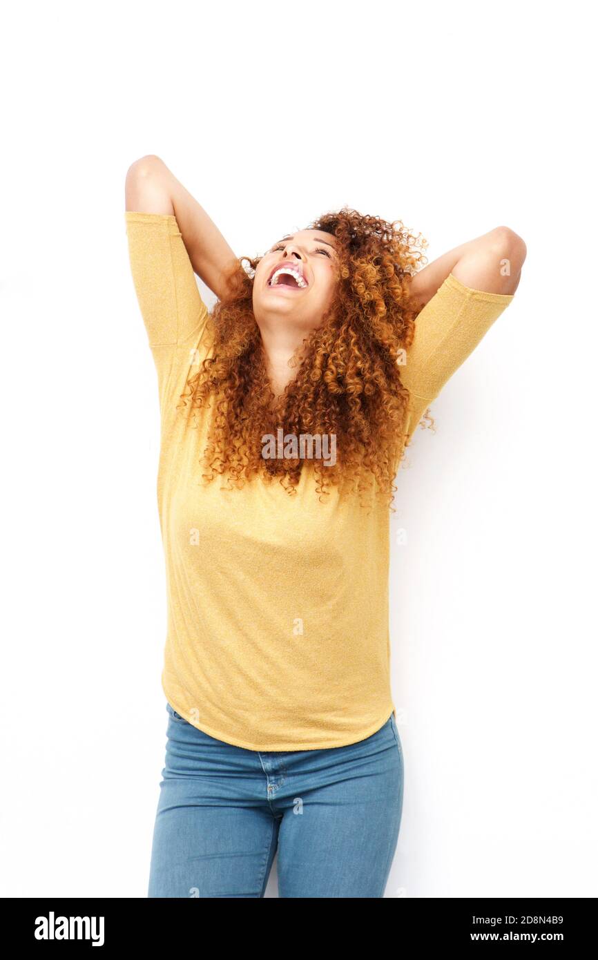 Portrait of carefree young woman laughing with hands behind head Stock ...