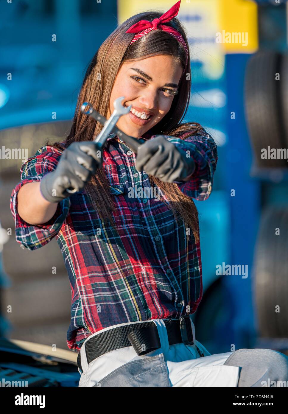 Vertical shot of a female mechanic holding tools Stock Photo - Alamy