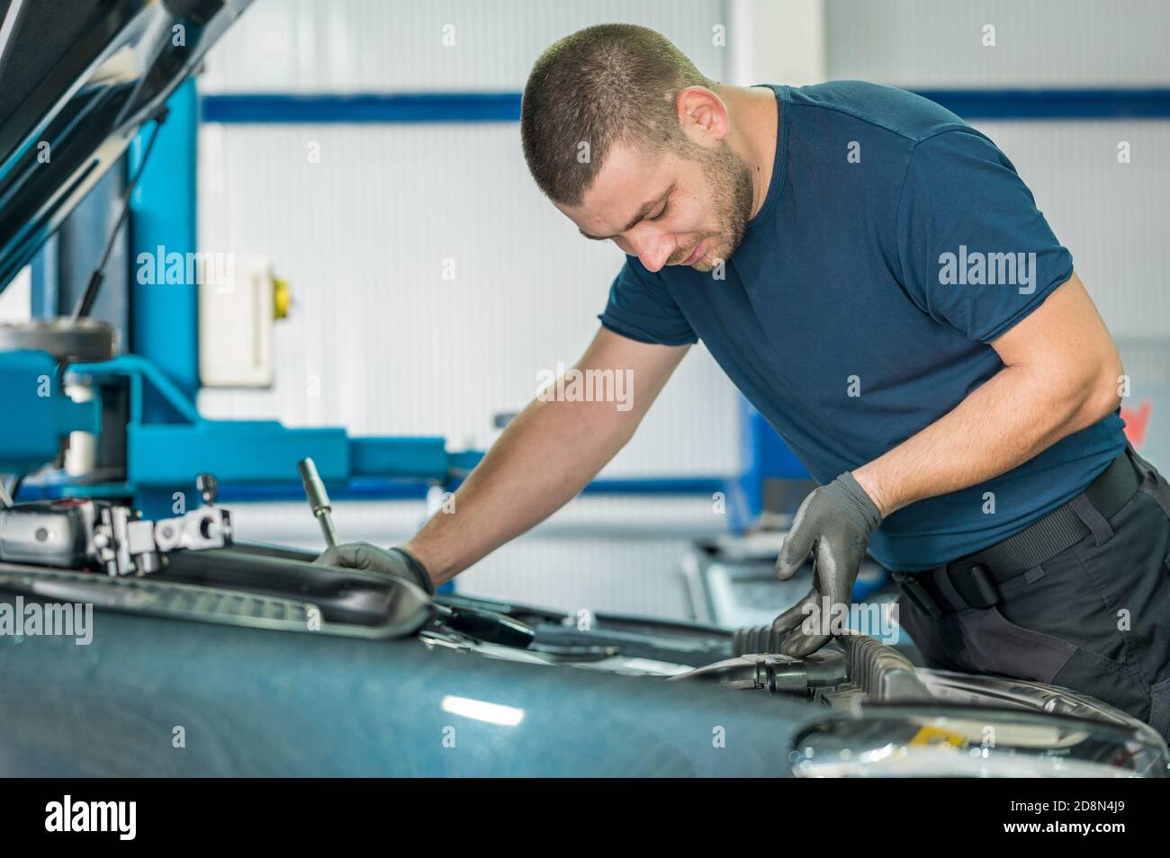 Professional mechanic fixing motor on hi-res stock photography and ...