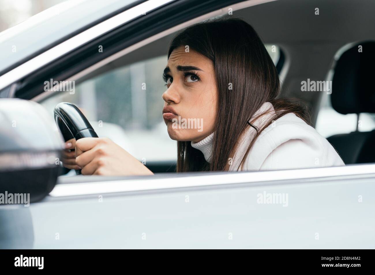 Attractive female posing behind the wheel of her car Stock Photo - Alamy