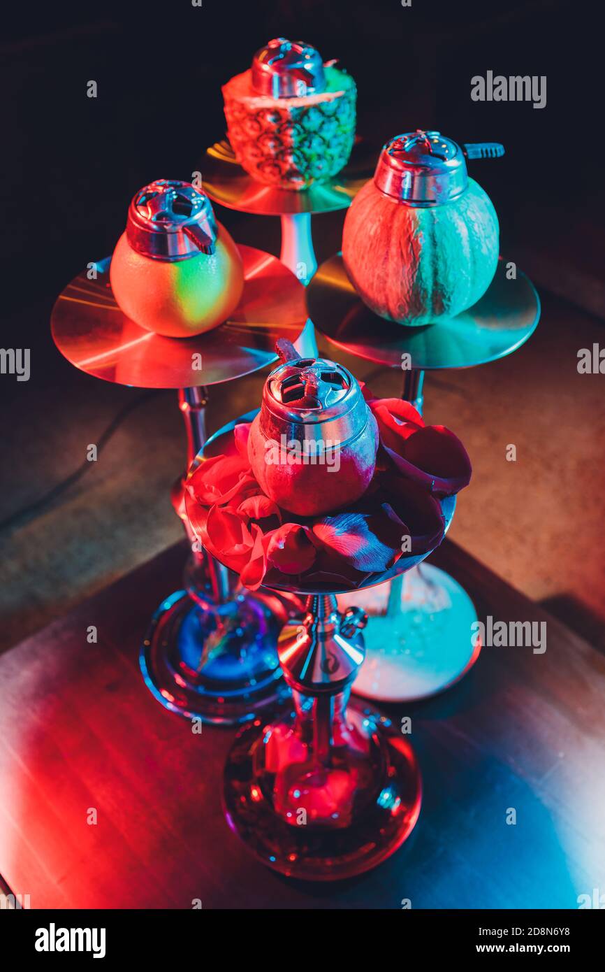 Red shisha hookah with smoke and red sparks on wood table brick, art ...