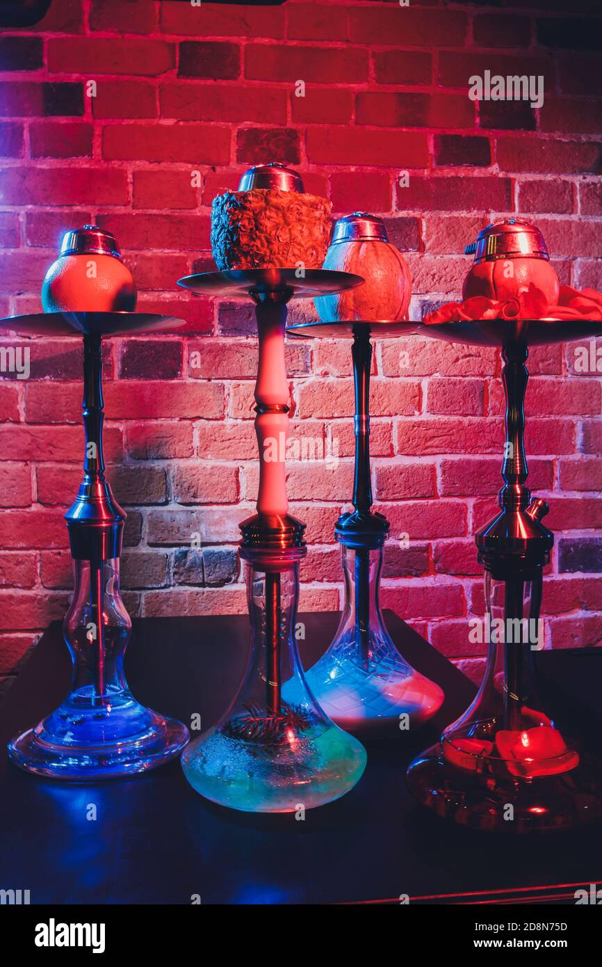 Red shisha hookah with smoke and red sparks on wood table brick, art ...